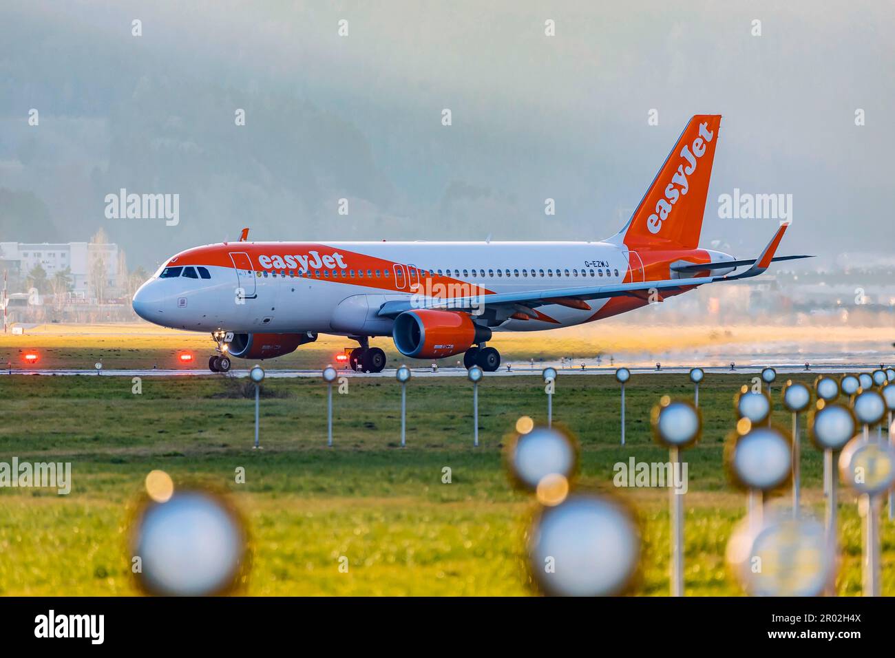 Aircraft on the tarmac, airfield lighting, easyJet, Airbus A320-200 ...