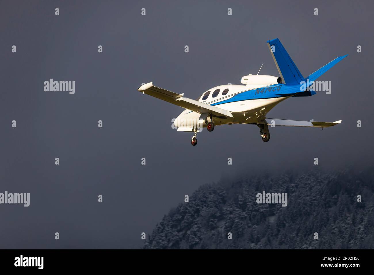 Aircraft Cirrus SF-50 Vision, private jet, snow lies on the mountains ...