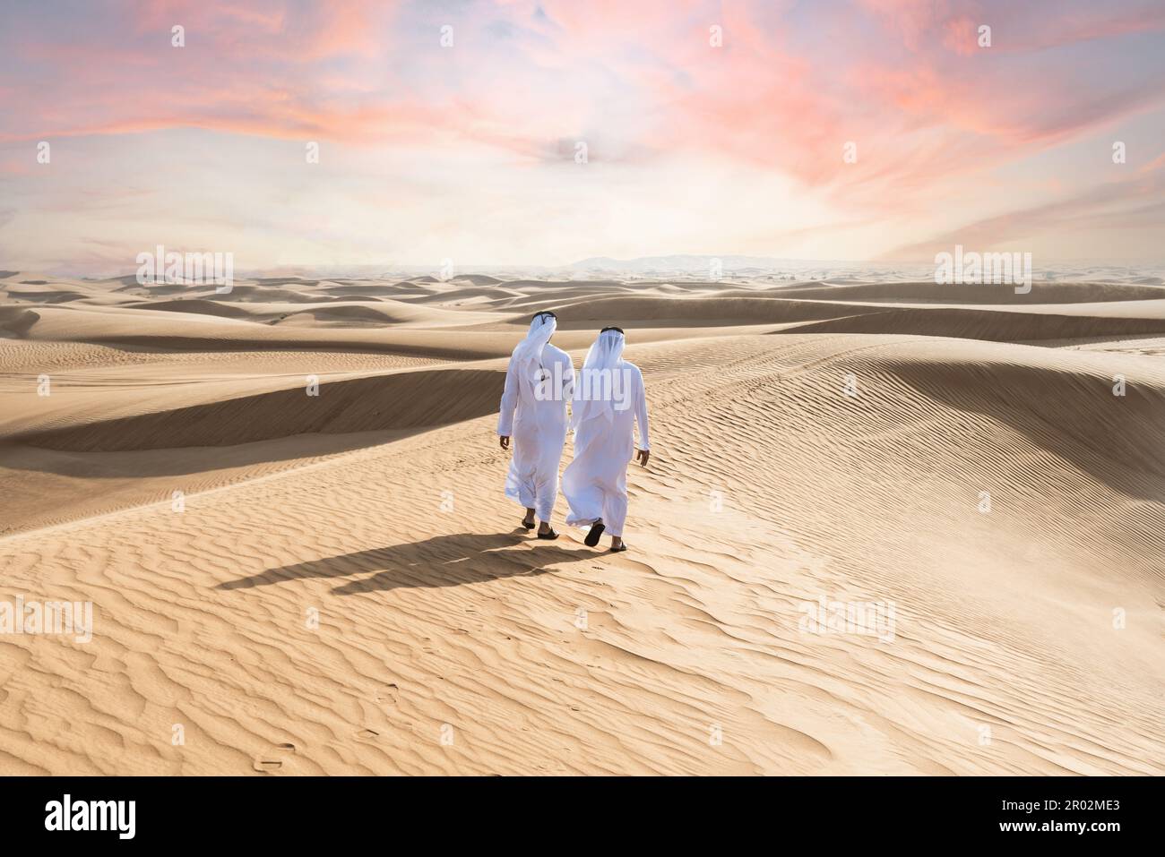 Two middle-eastern men wearing traditional emirati arab kandura bonding ...
