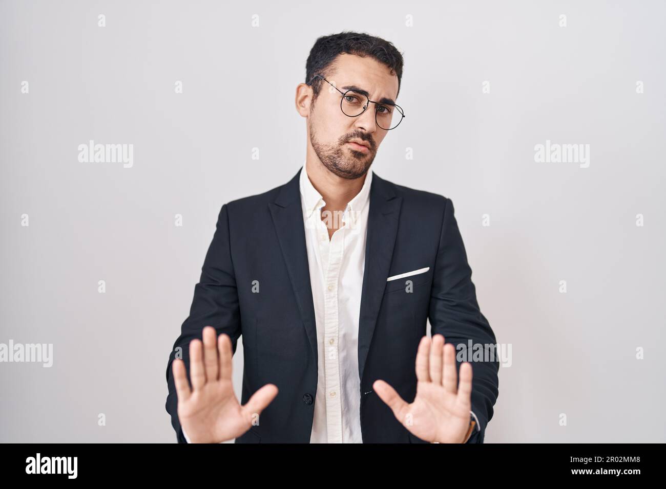 Handsome business hispanic man standing over white background moving ...