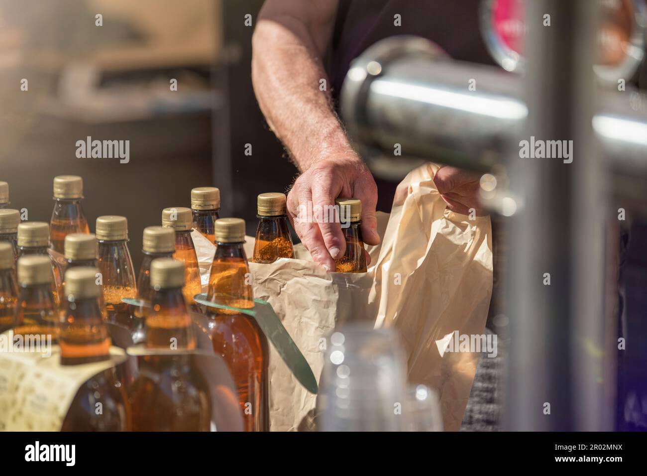 Craft beer vendor packaging beer bottles for a customer. The concept of ...