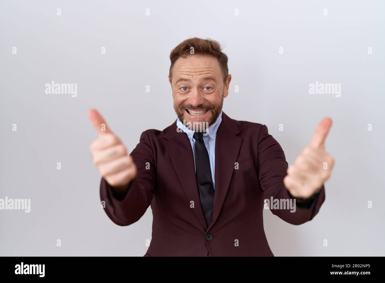 Middle age business man with beard wearing suit and tie approving doing ...