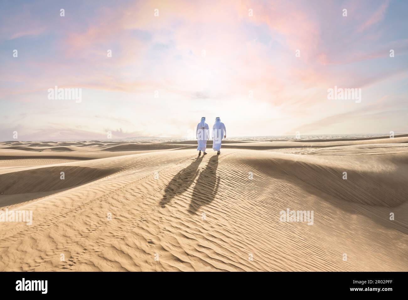 Two middle-eastern men wearing traditional emirati arab kandura bonding ...