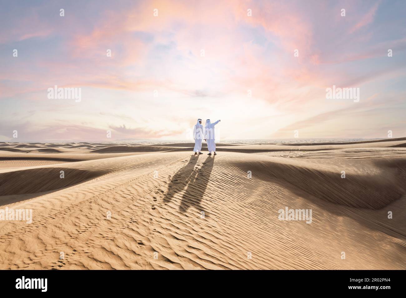 Two middle-eastern men wearing traditional emirati arab kandura bonding ...