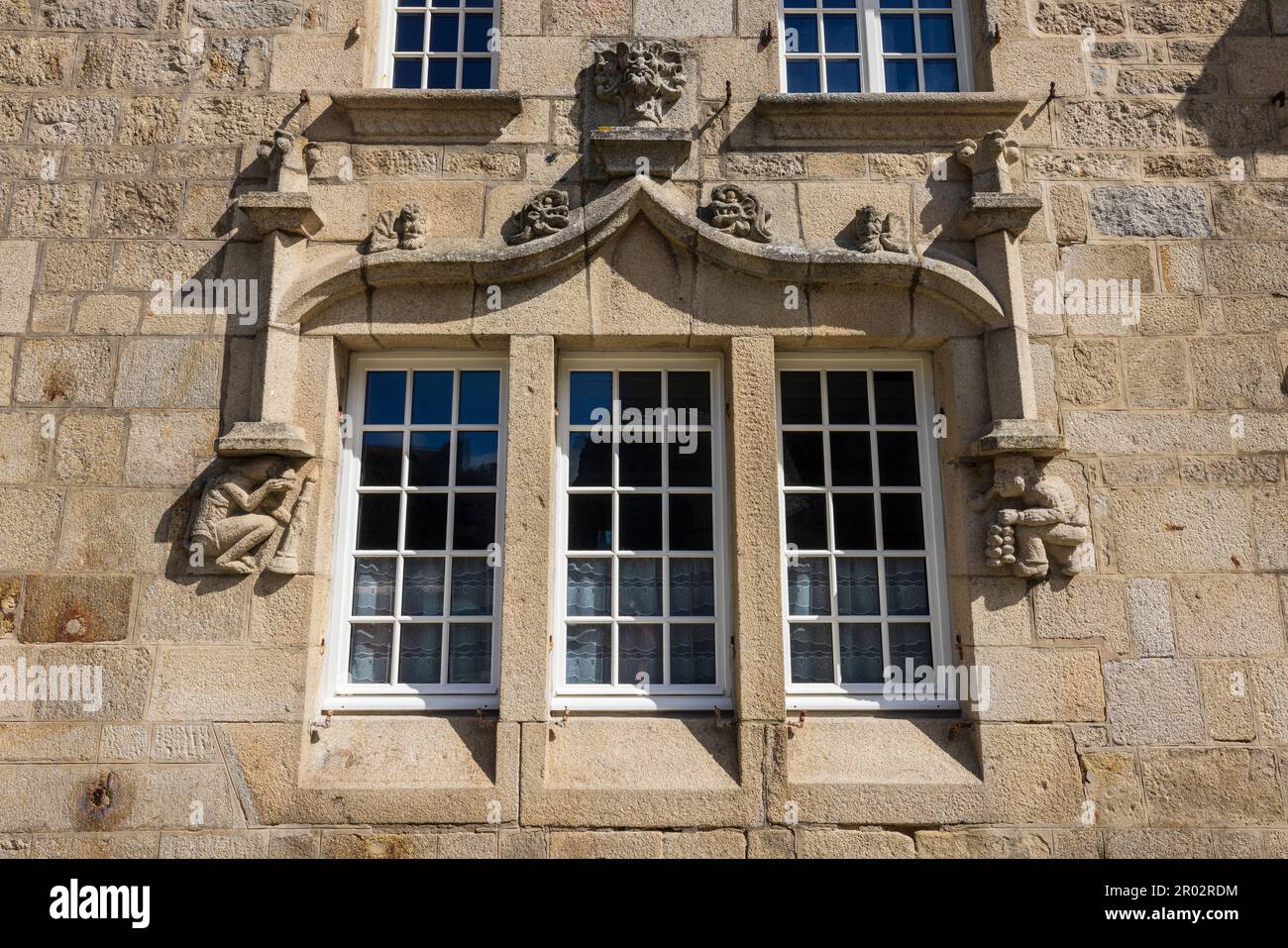 Ornate stone carvings on a house in the old quarter of Roscoff ...