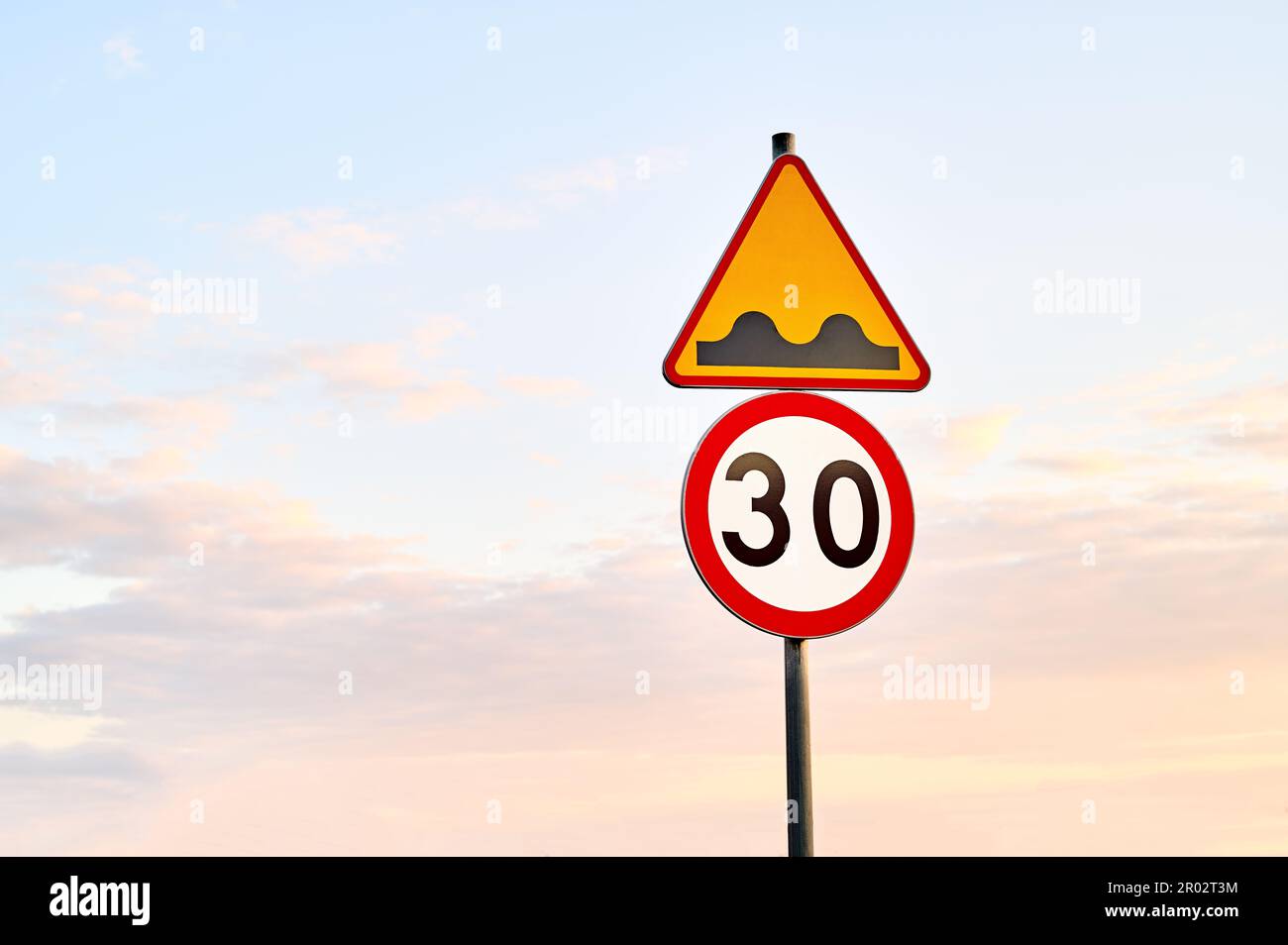 Two road signs: beware of potholes and a speed limit of 30 km/h Stock ...