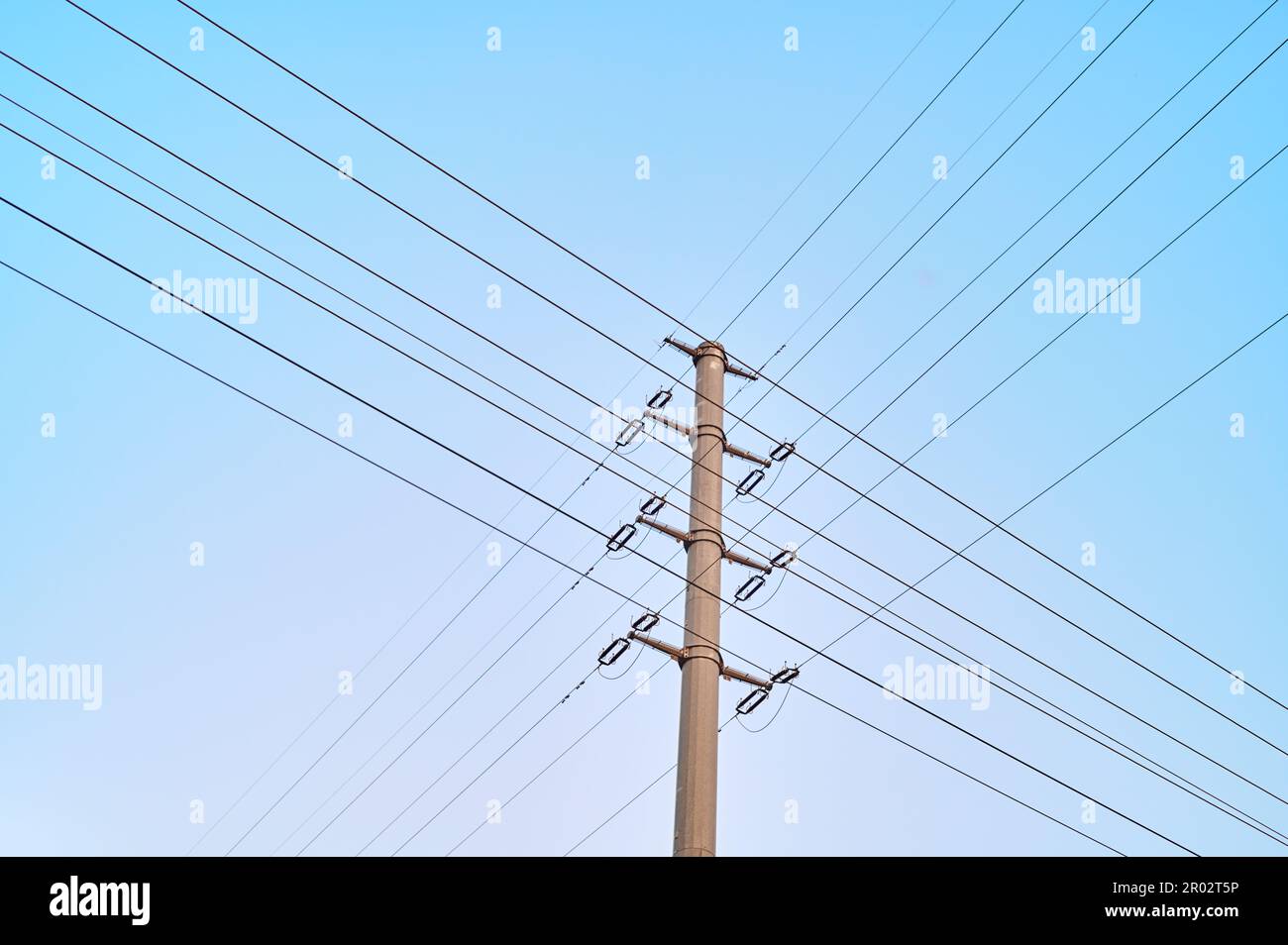 Crossing high-voltage wires against the sky Stock Photo - Alamy