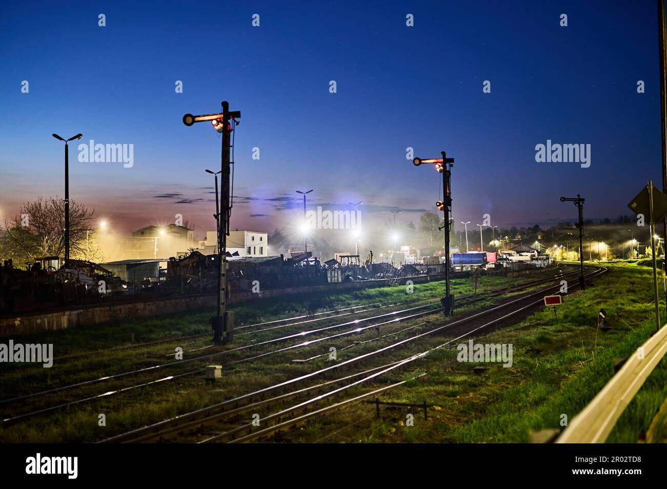 A gloomy; gray freight train station on the outskirts of the city at ...
