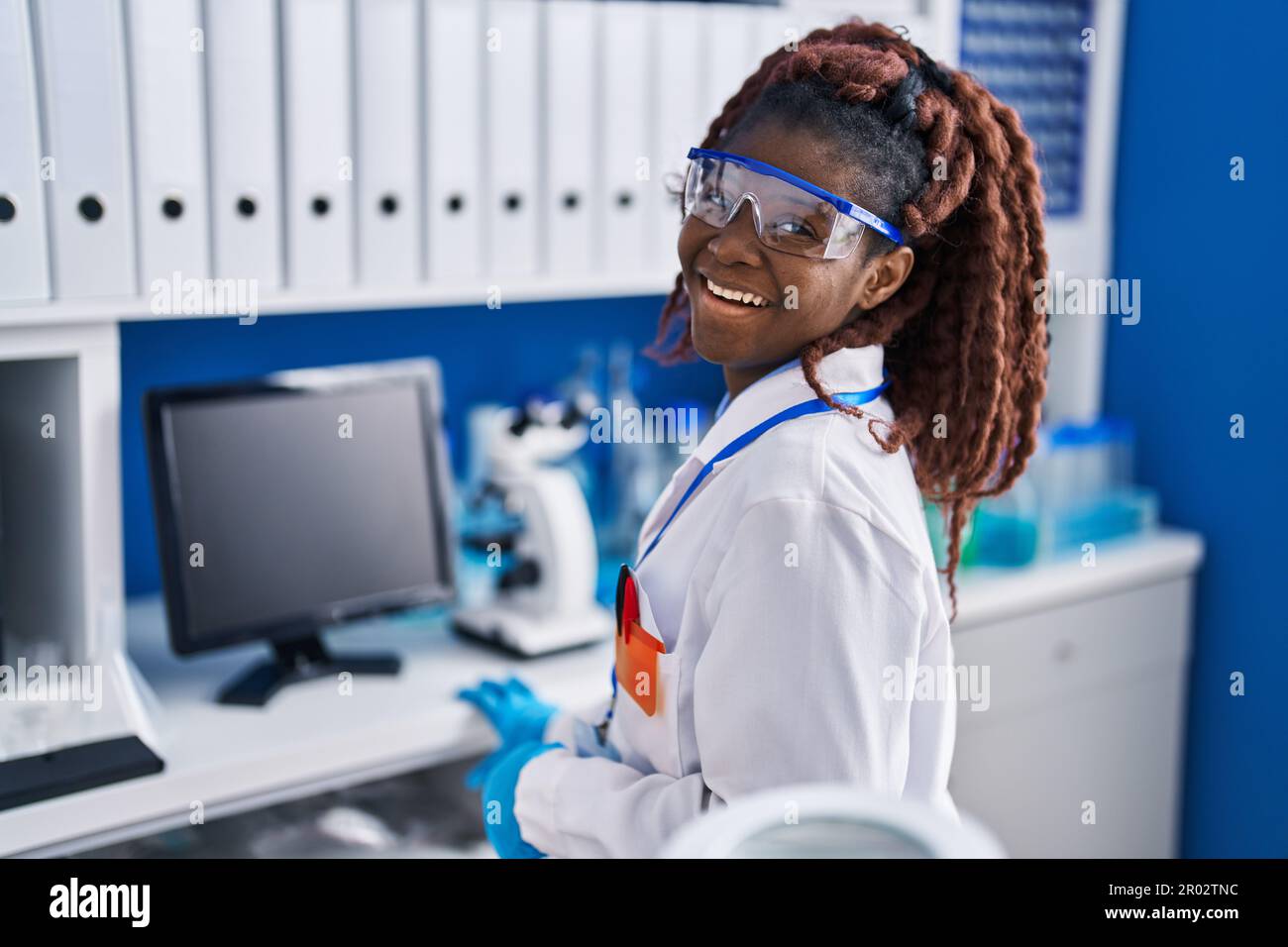 African american woman scientist smiling confident standing at laboratory Stock Photo - Alamy