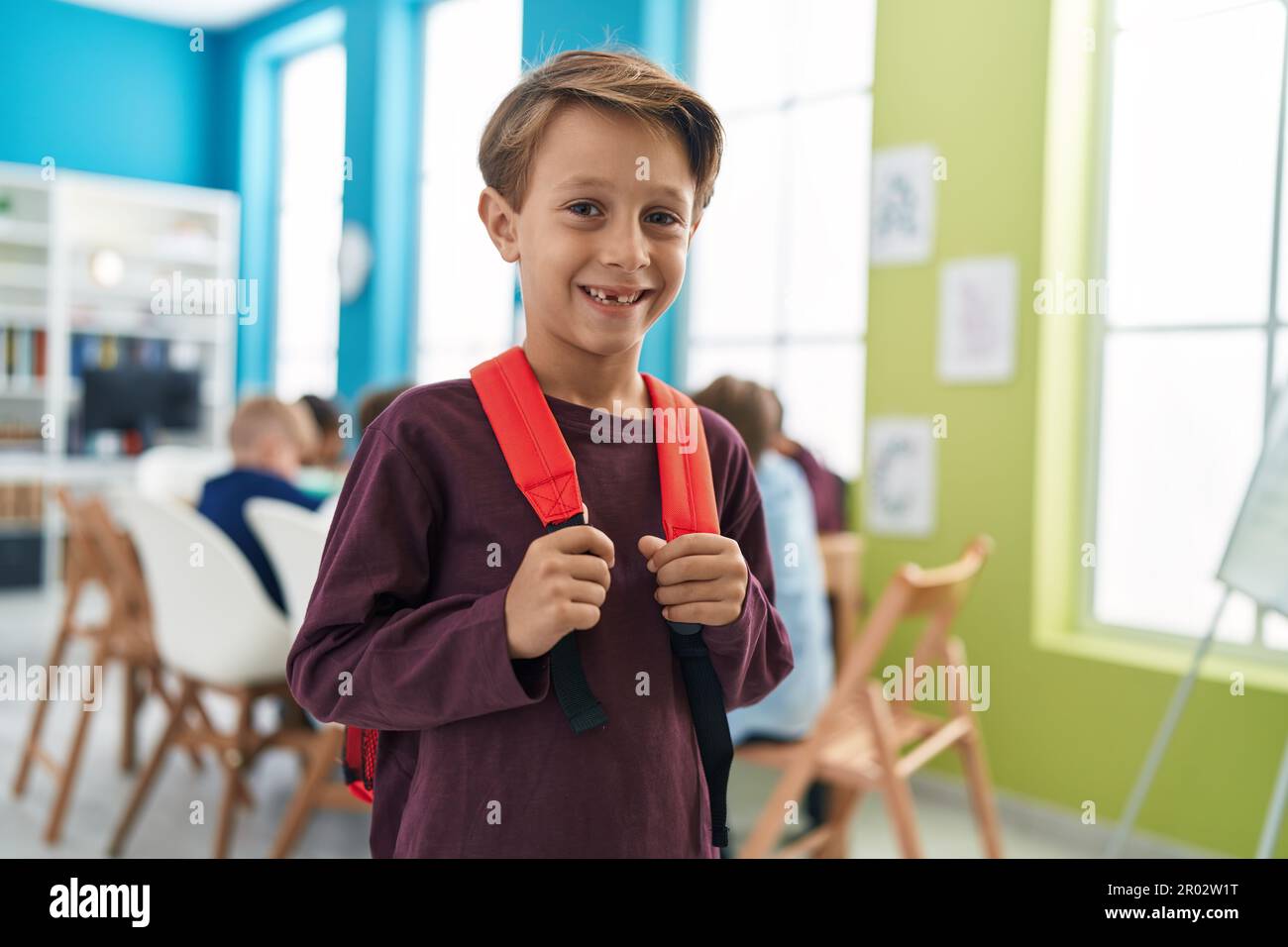 Adorable caucasian boy student smiling confident standing at classroom ...