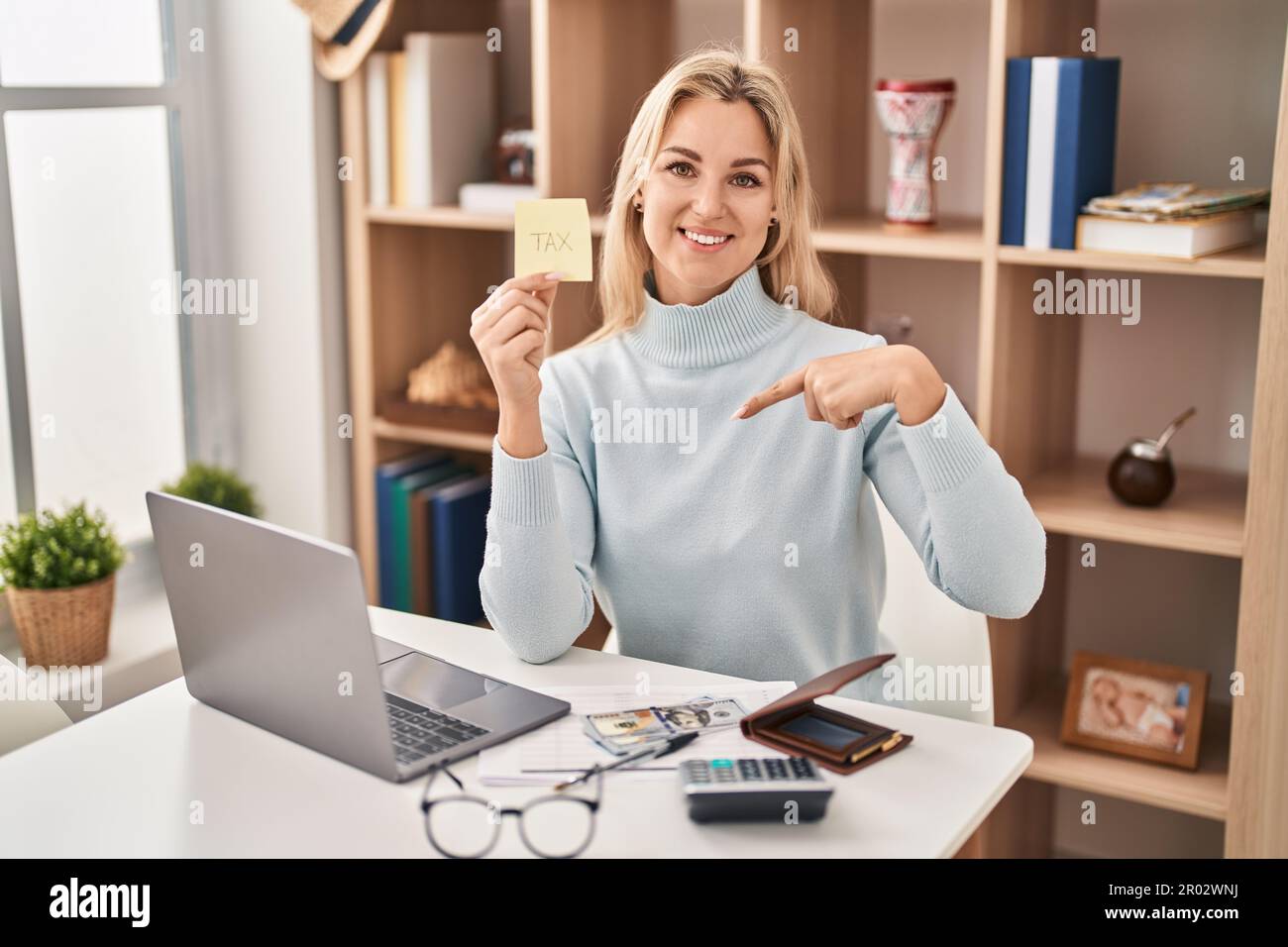 Young caucasian woman calculating money savings pointing finger to one ...