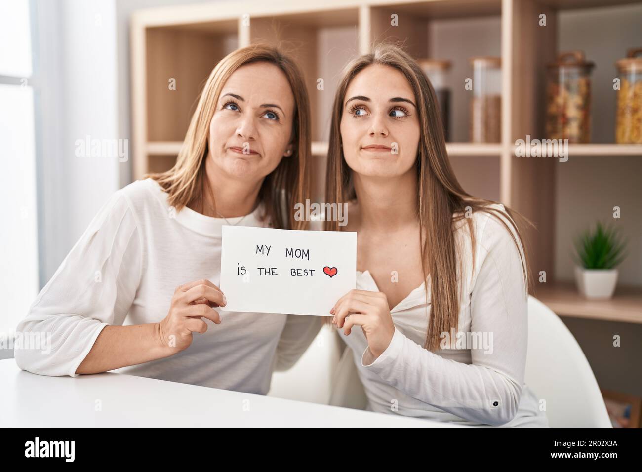 Middle age mother and young daughter holding my mom is the best banner ...