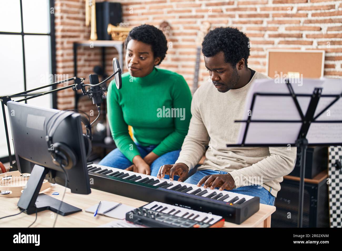 African american man and woman music group singing song playing ...