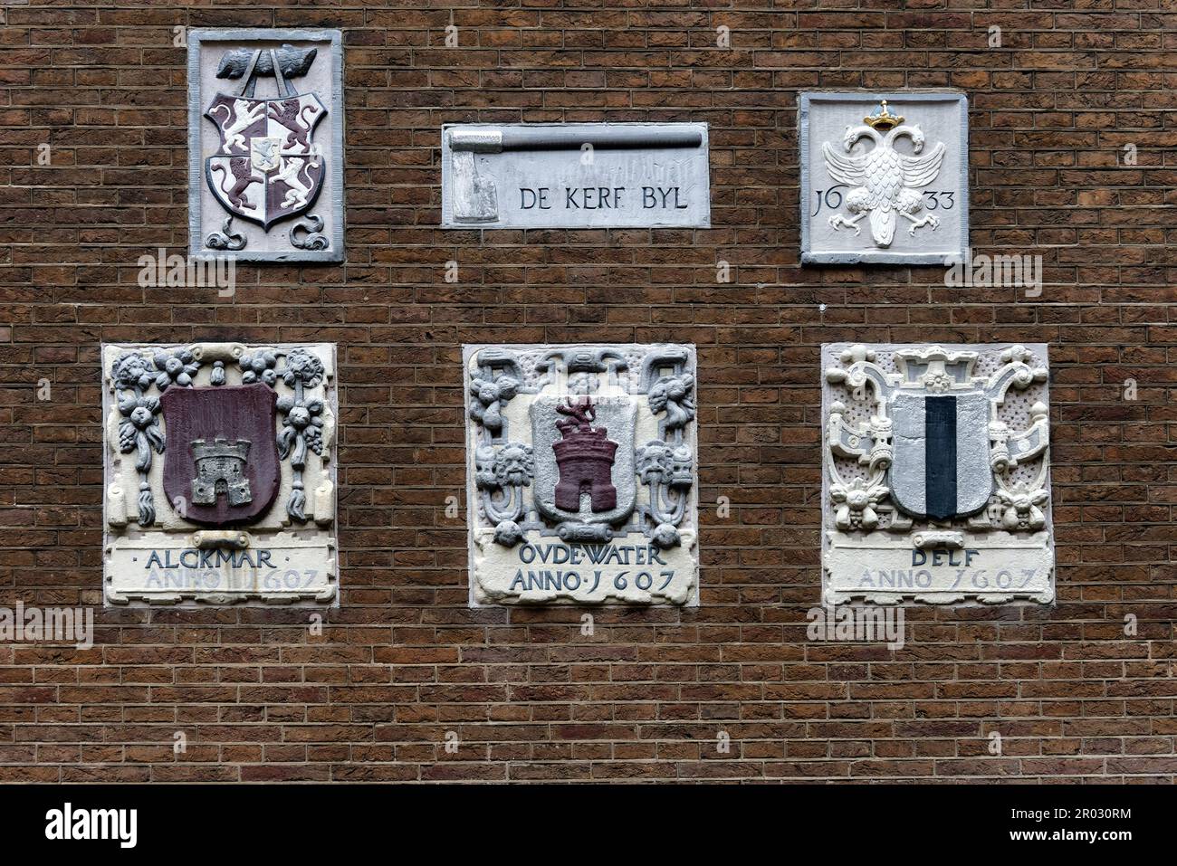 Old gables on a wall showing crests in Amsterdam, Holland, Netherlands ...