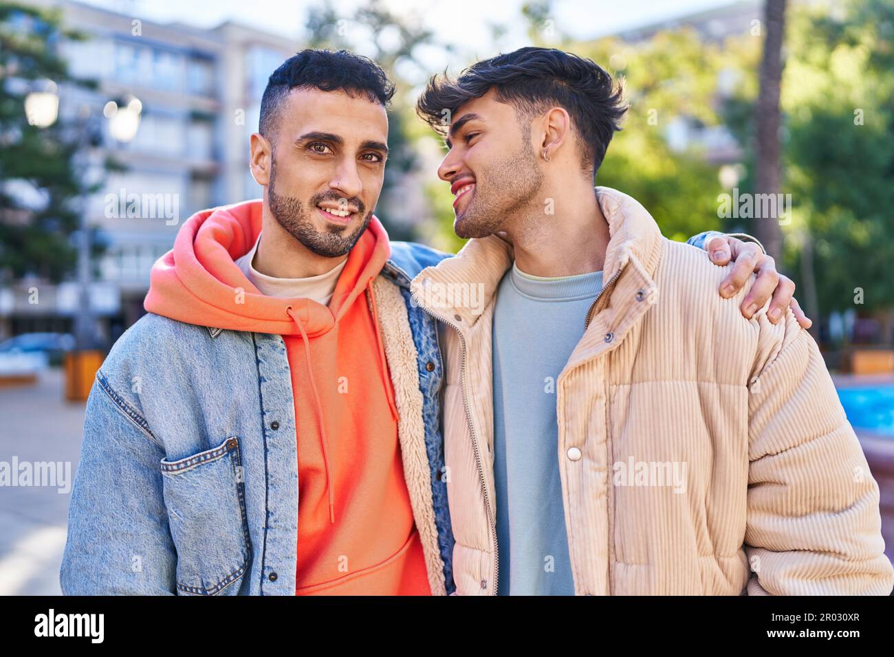 Two man couple hugging each other standing at park Stock Photo - Alamy