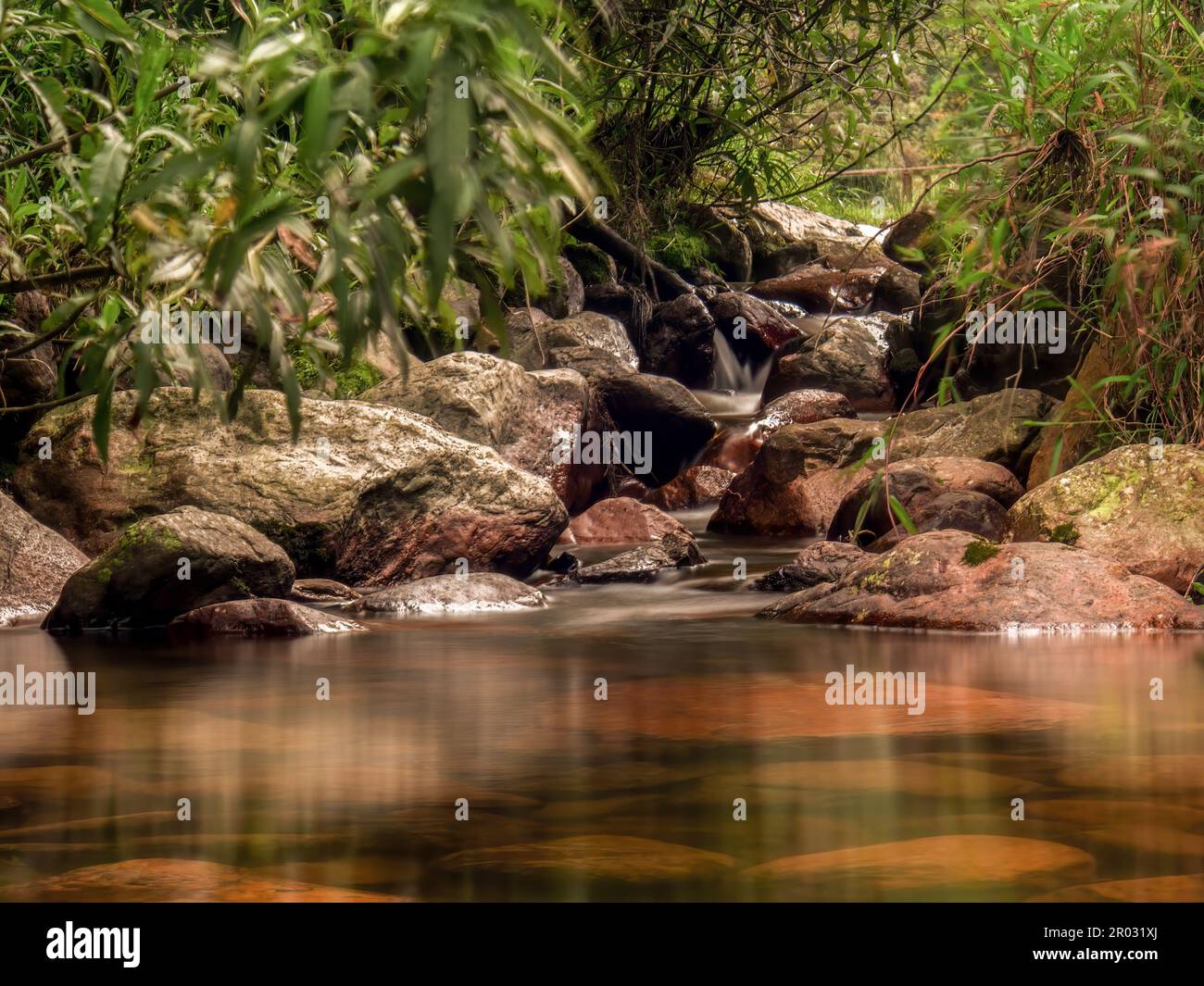 Long-exposure photography of the stream and waterfalls of a rocky creek ...