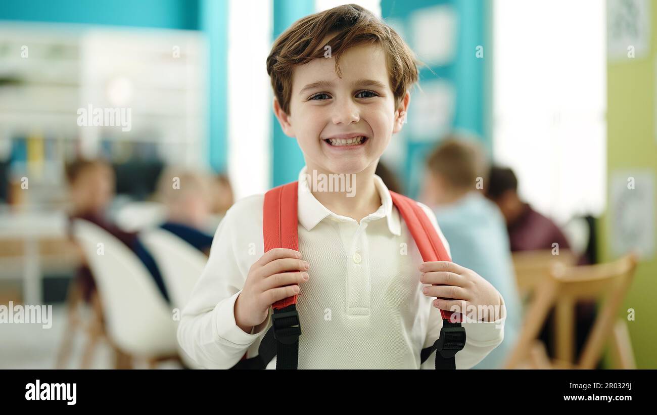 Adorable caucasian boy student smiling confident standing at classroom ...