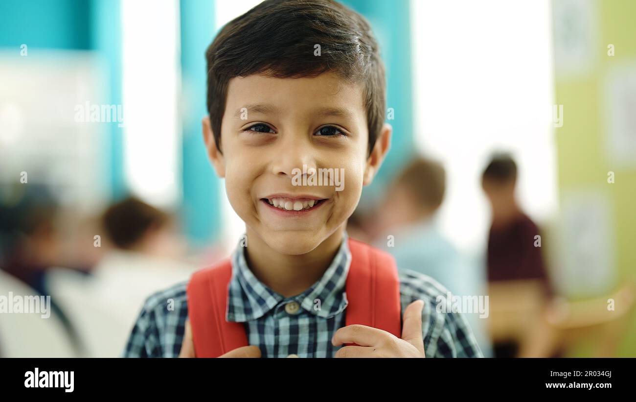 Adorable hispanic boy student smiling confident standing at classroom ...