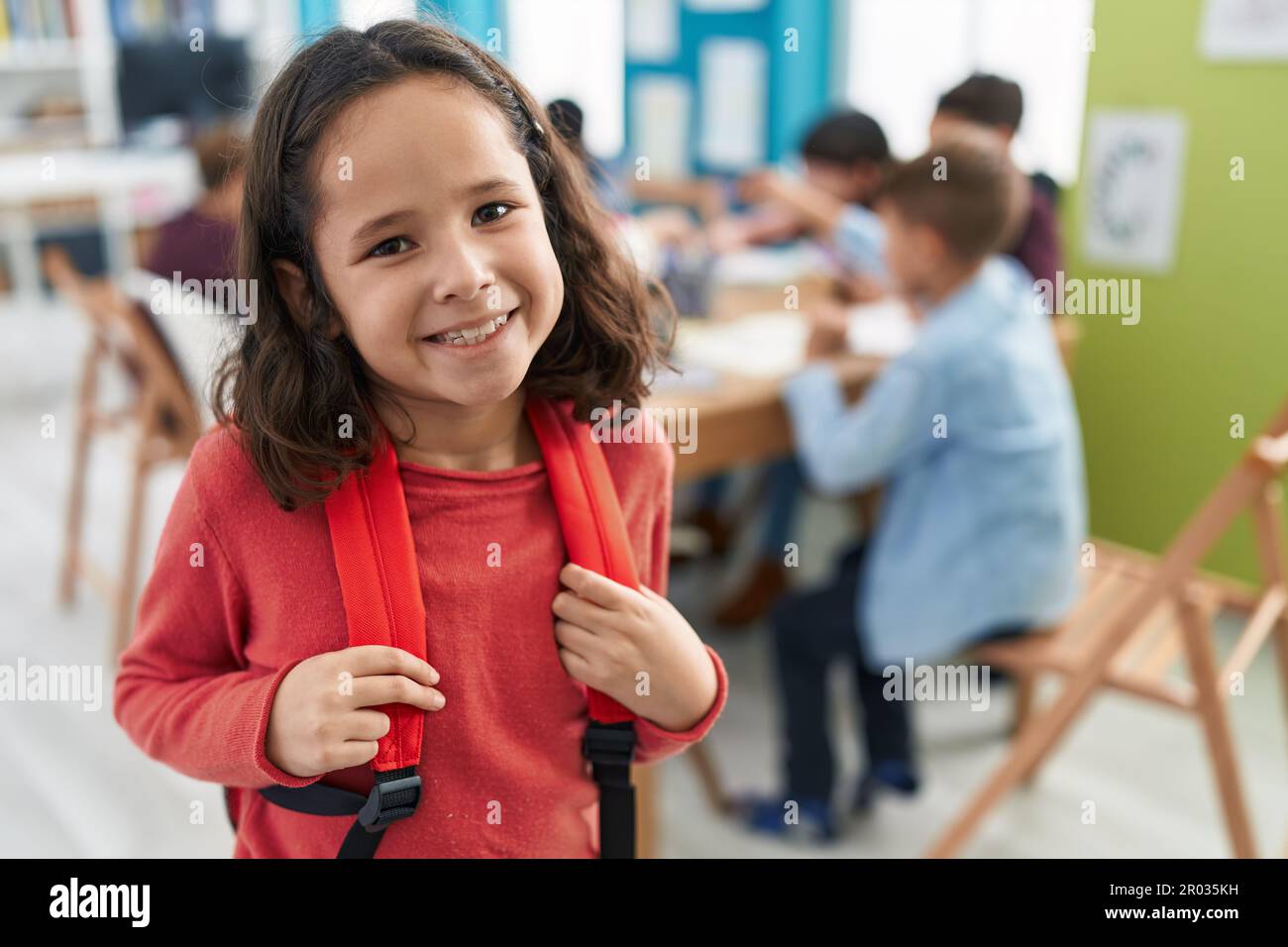 Adorable hispanic girl student smiling confident standing at classroom ...