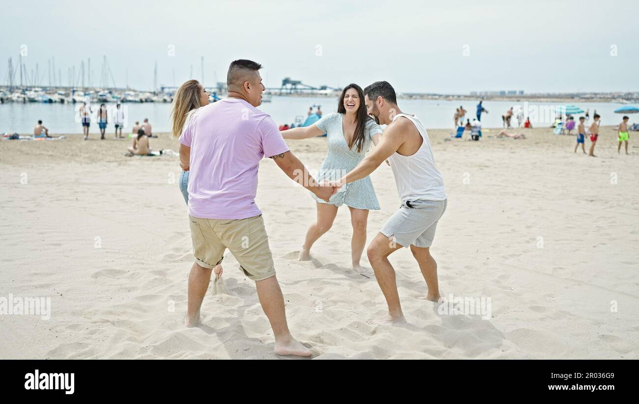 Group of people smiling confident dancing with hands together at beach ...