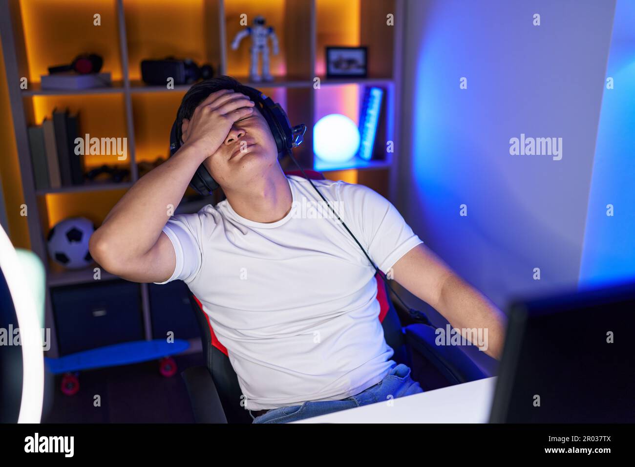 Young chinese man streamer stressed using computer at gaming room Stock ...