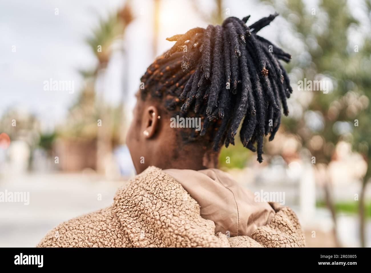 African american woman standing on back view at park Stock Photo - Alamy