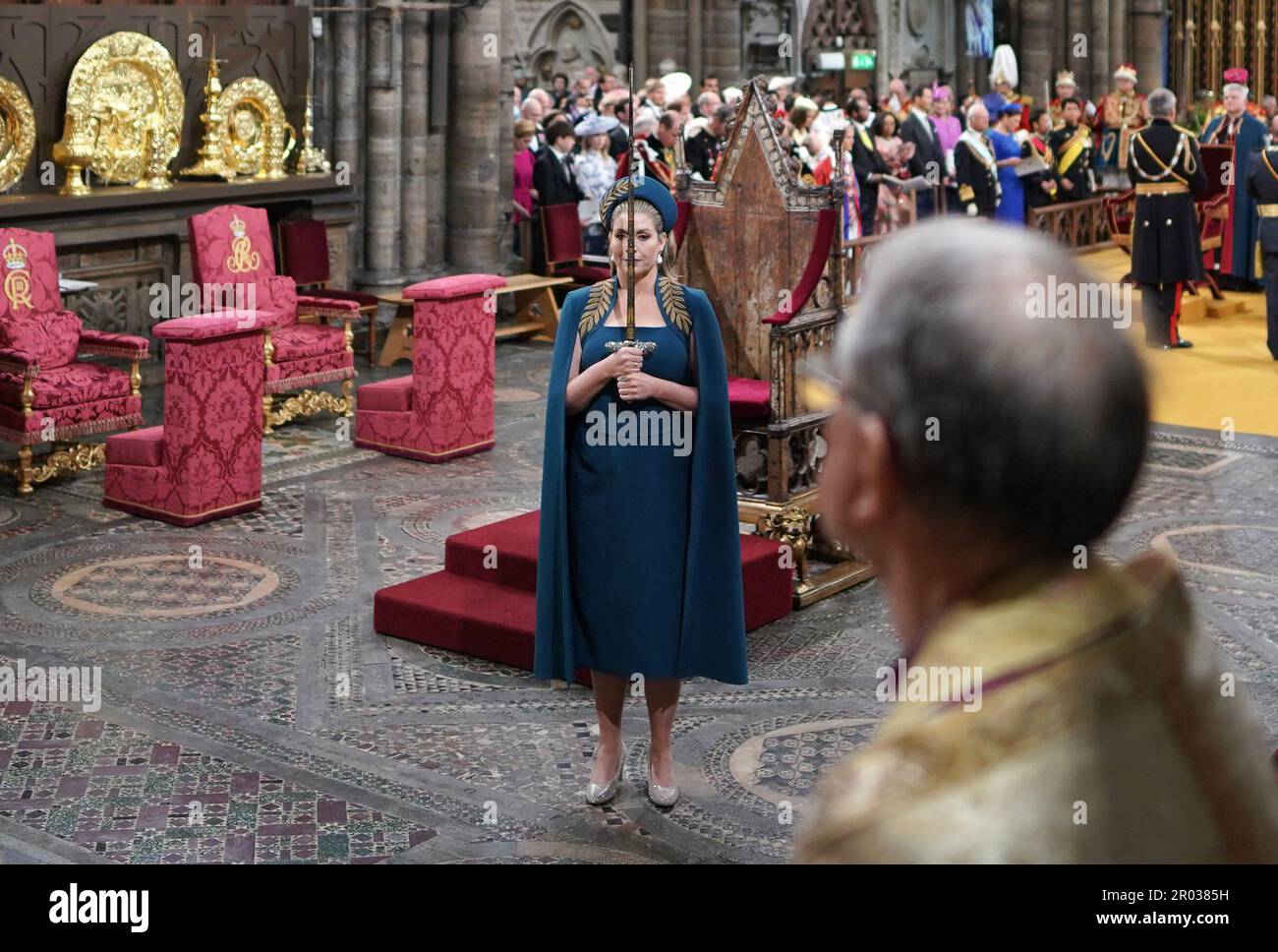 Penny Mordaunt holds the Swords of State at the coronation ceremony of ...