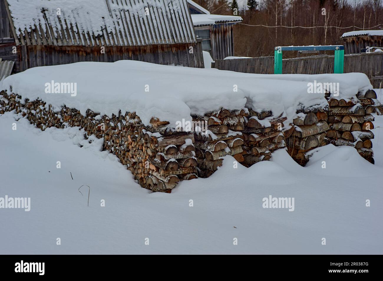Firewood in stack under snow hi-res stock photography and images - Alamy