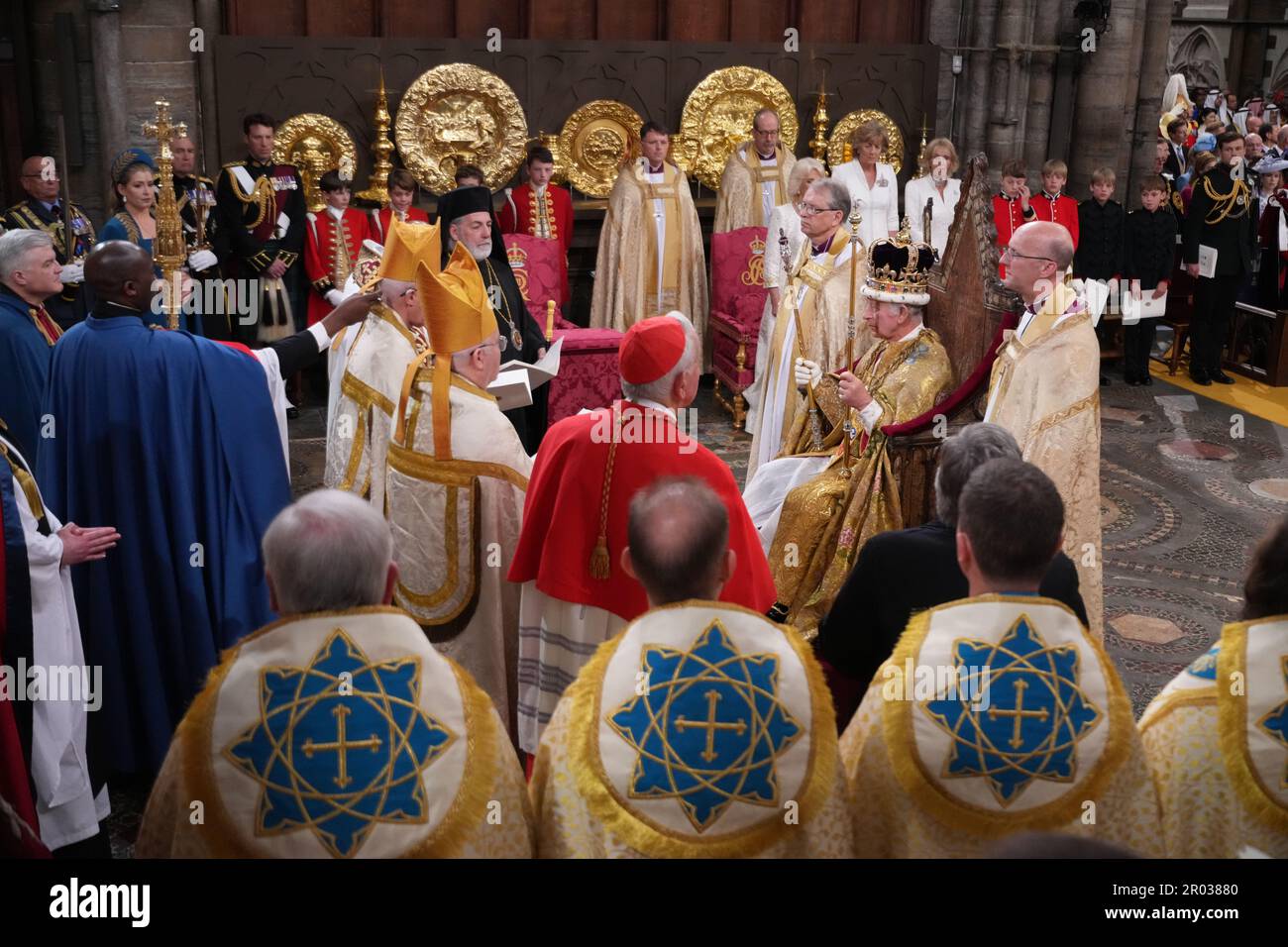 King Charles III in St Edward's Crown surrounded by faith leaders ...