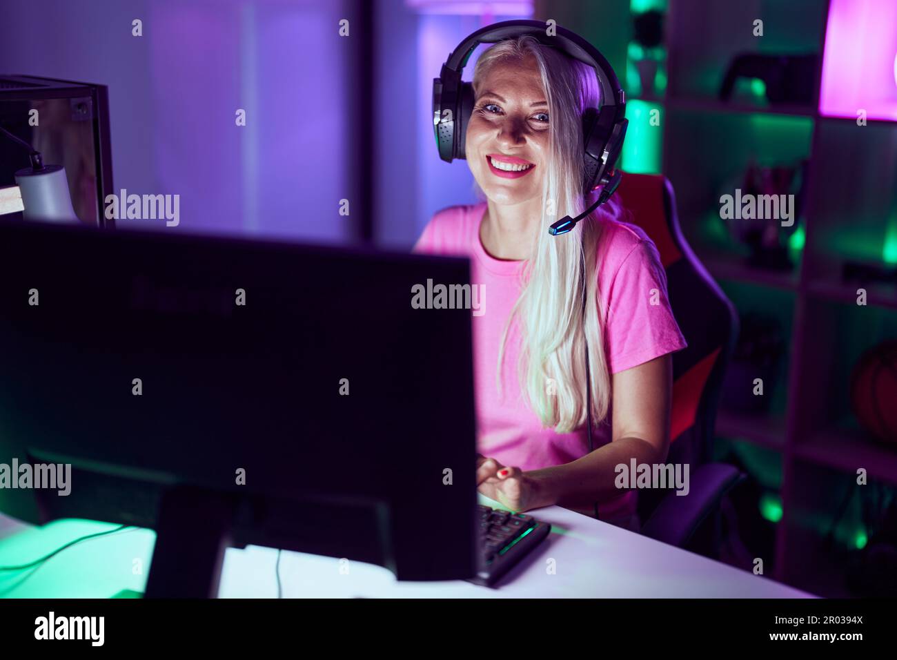 Young blonde woman streamer smiling confident using computer at gaming ...