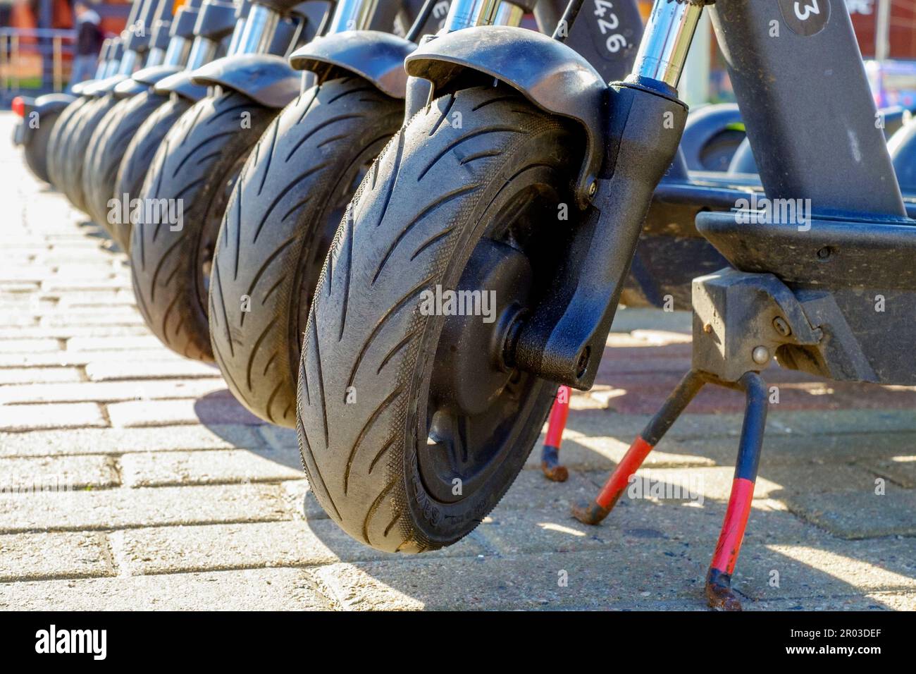 Close-up of the wheels of electric push scooters. Eco-friendly urban ...