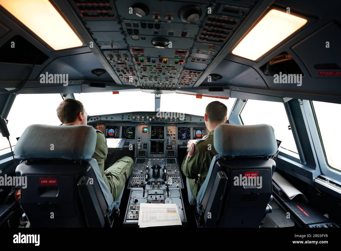 Crew members in the cockpit of a Royal Air Force (RAF) Voyager, flying ...