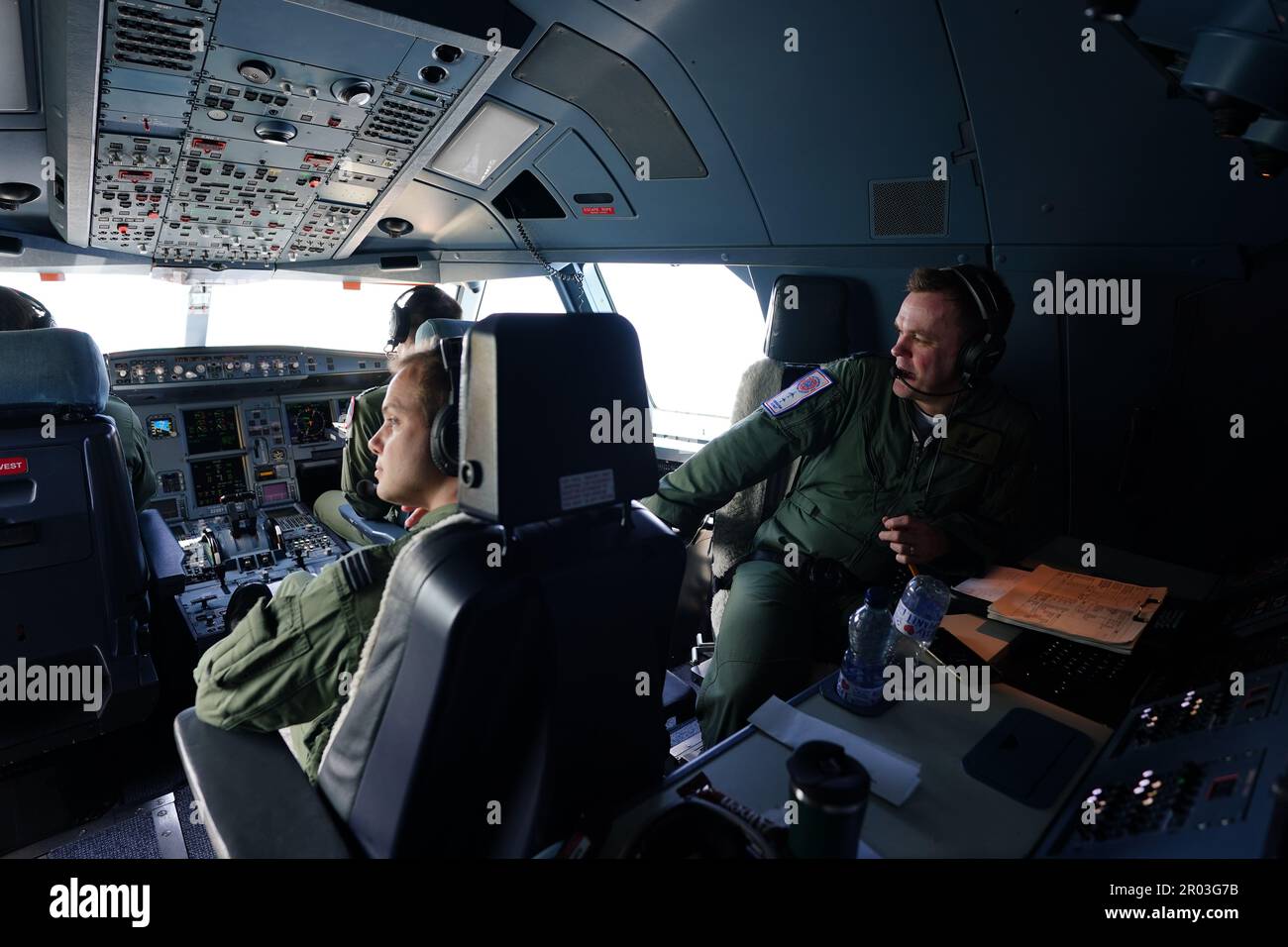 Crew members in the cockpit of a Royal Air Force (RAF) Voyager, flying ...
