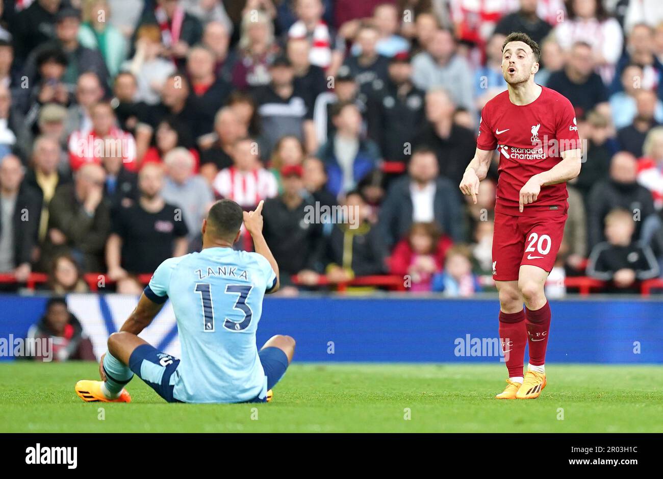 Brentford's Mathias Jorgensen (left) and Liverpool's Diogo Jota clash ...