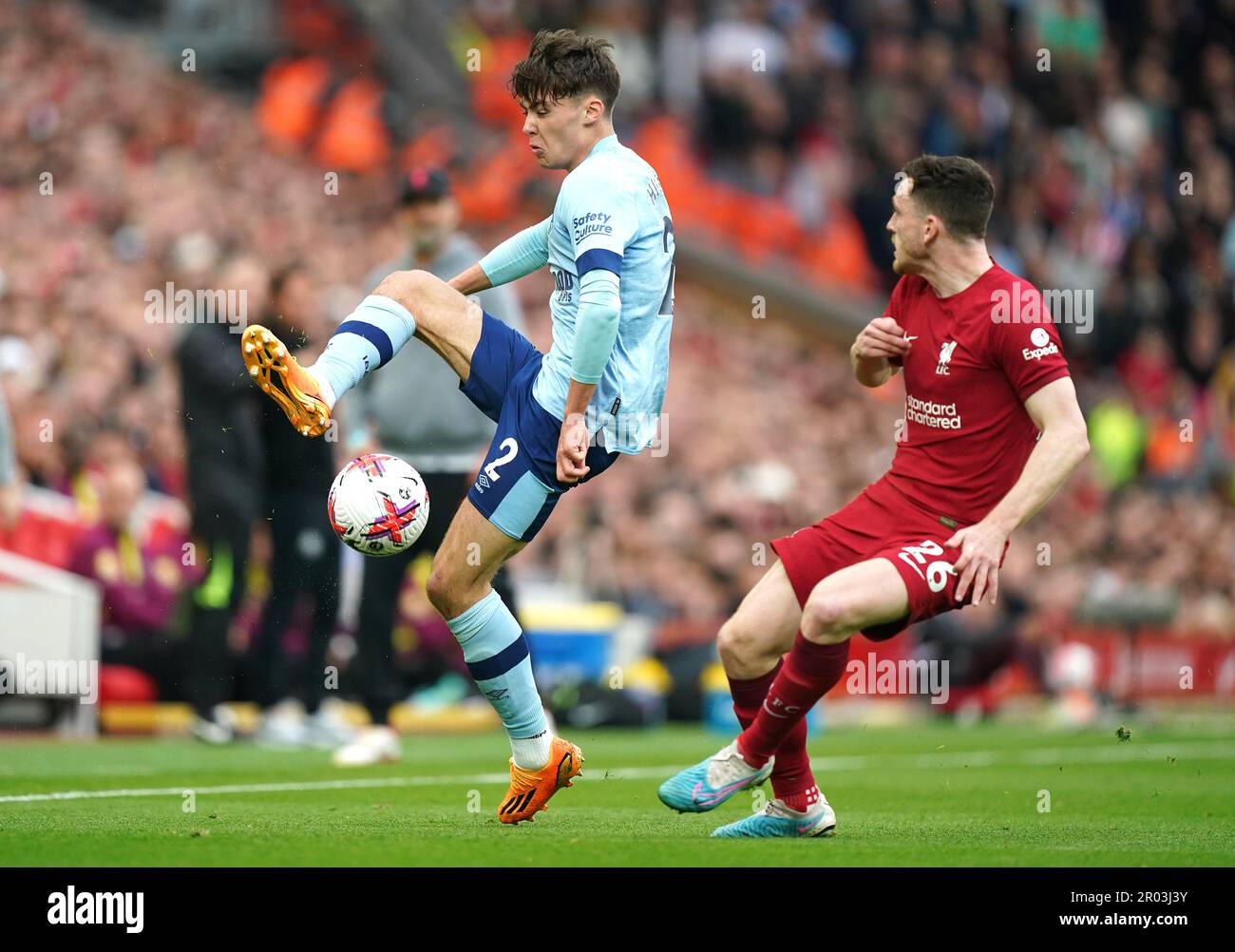 Brentford's Aaron Hickey (left) and Liverpool's Andrew Robertson battle ...