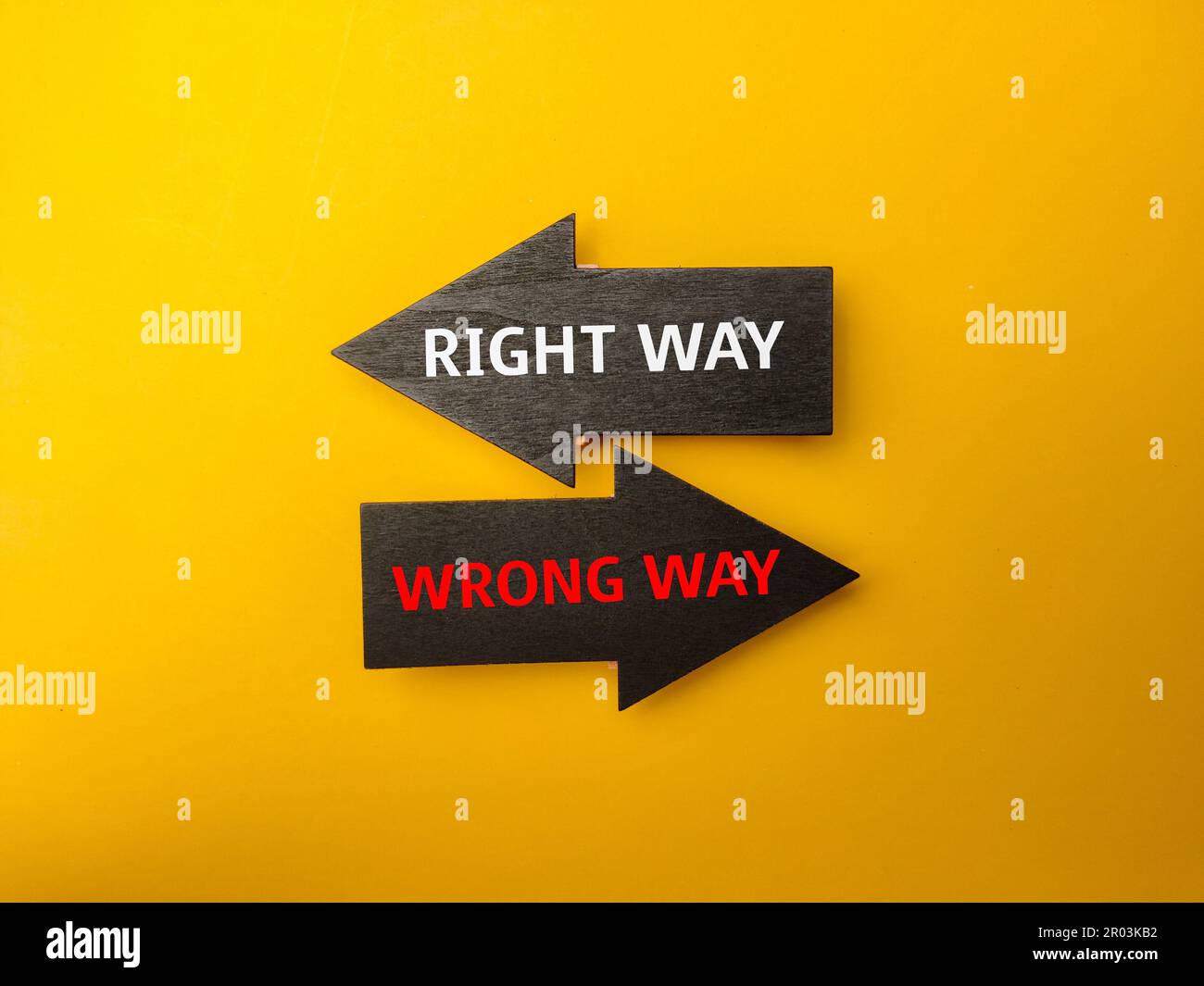 Two signs with arrows pointing in opposite directions, one labeled ...