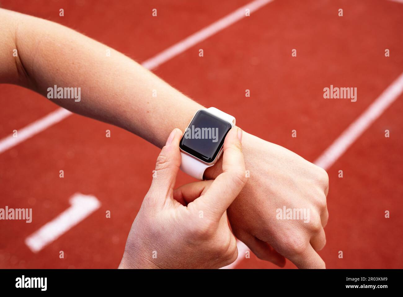 Technology in sports, digital wristwatch on hand of athlete and running ...