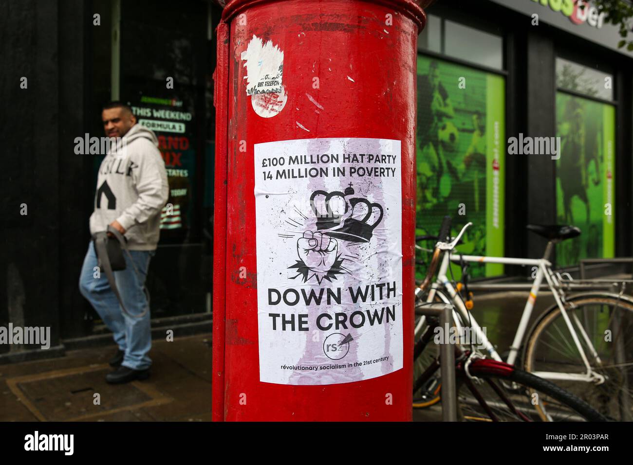London, UK. 6th May, 2023. A man walks past an anti monarchy poster ...