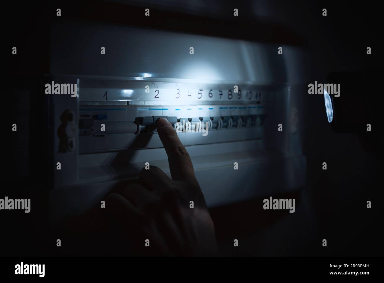 Investigate a home fuse box during a power outage. Blackout concept ...