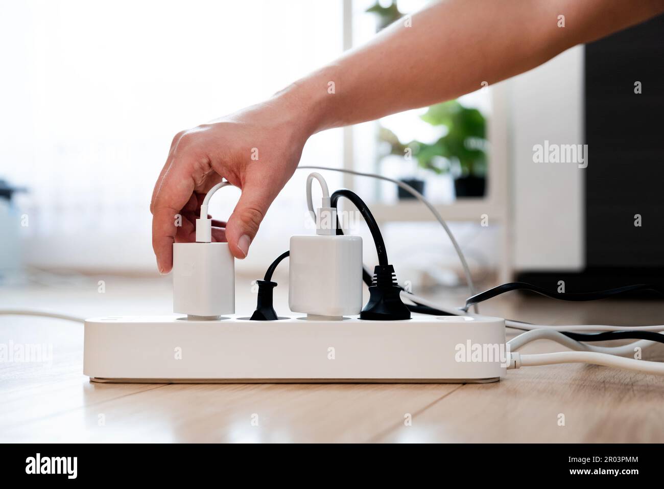 Hand holding plug outlet hi-res stock photography and images - Alamy