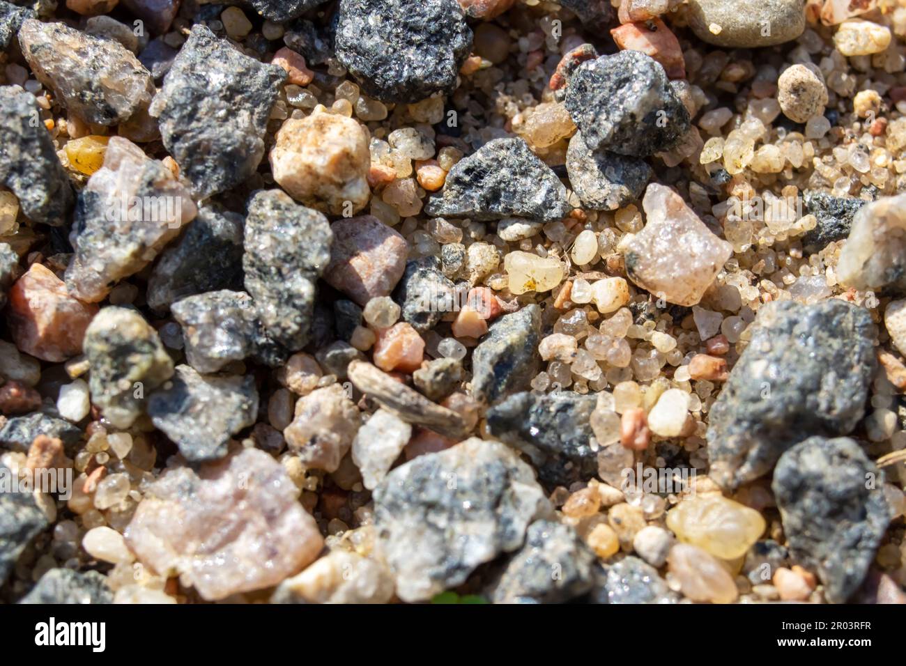 Small pebbles in the sand close up, macrophoto Stock Photo - Alamy