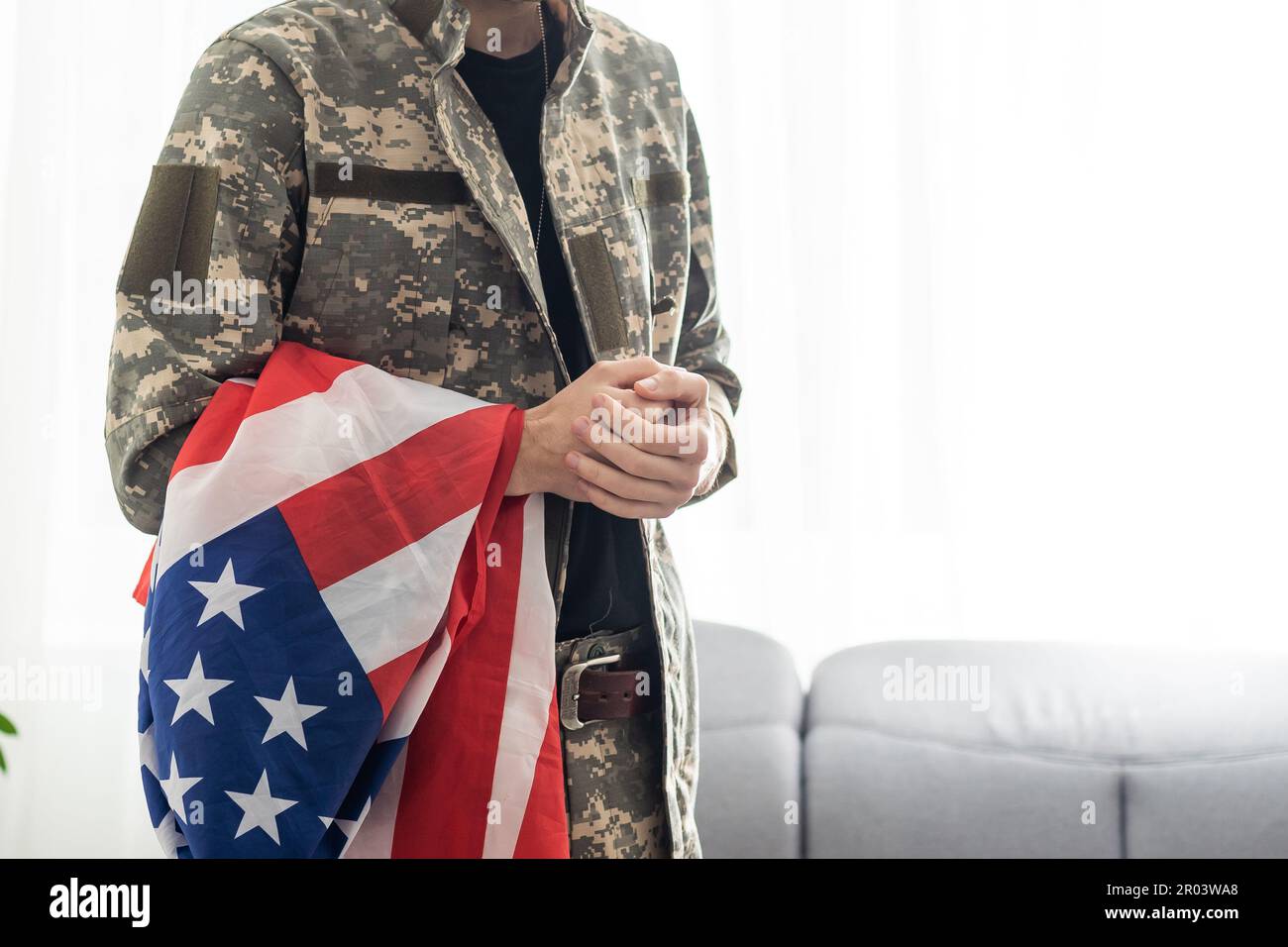 upset American soldier holding flag of United States while crying ...