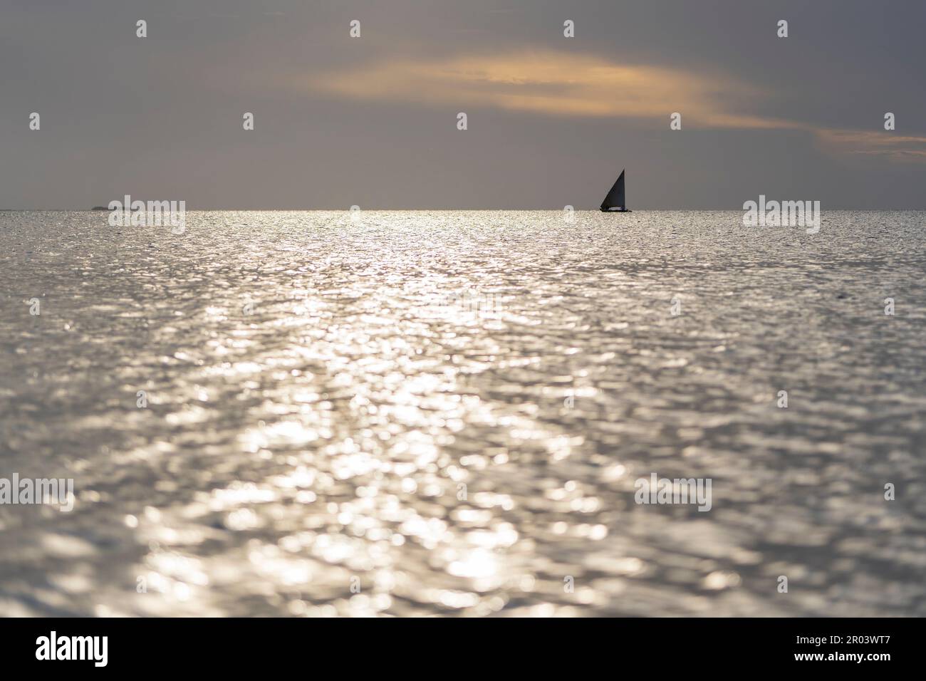 Traditional fisherman dhow boat during sunset on Indian ocean in island ...