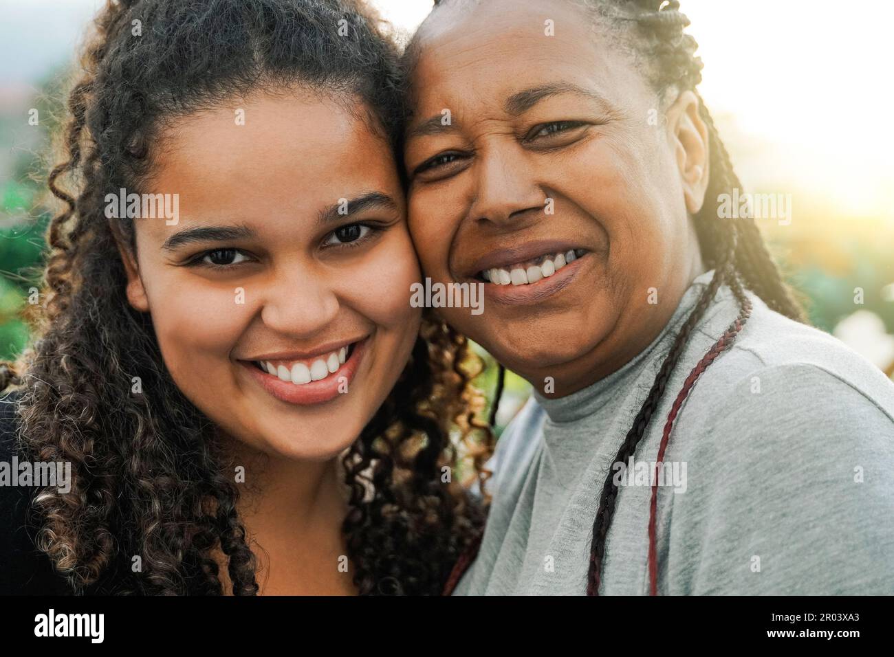 Portrait of happy African mother and daughter having fun outdoor in summer day - Love family ...