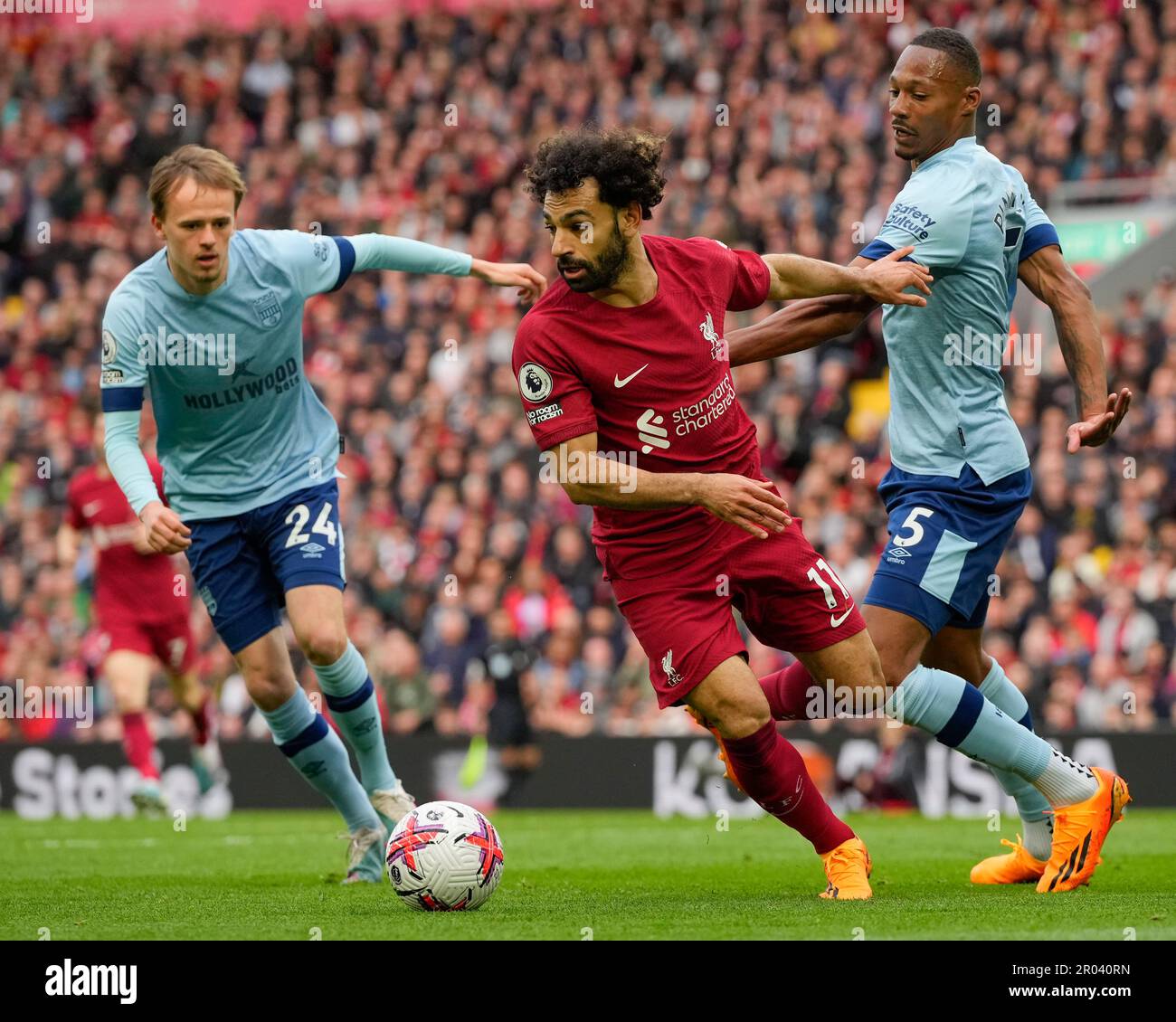 Mohamed Salah #11 of Liverpool turns Ethan Pinnock #5 of Brentford ...