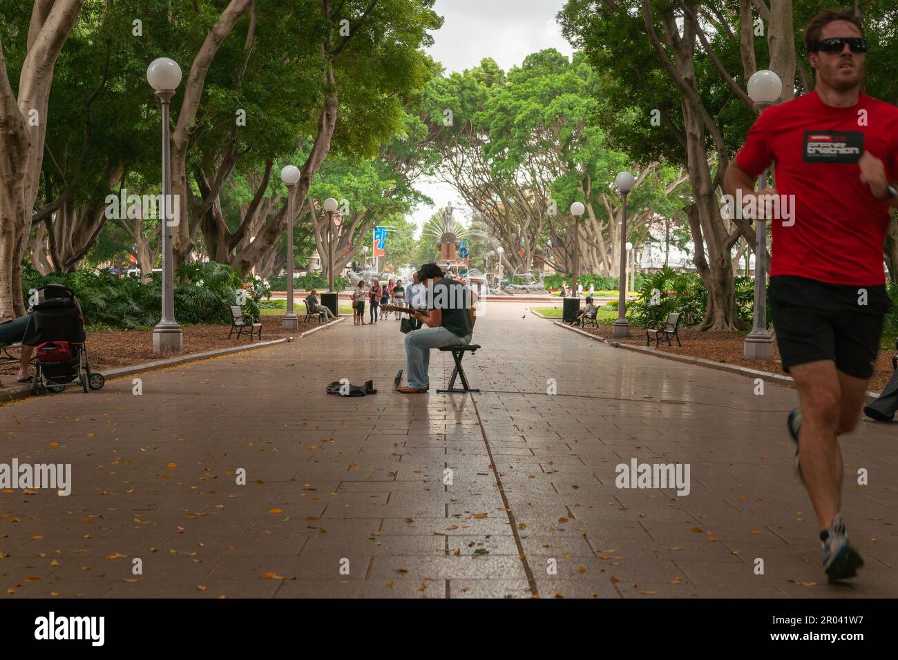 Sydney Australia - January 29 2011; Busker sitting on stool in middle ...