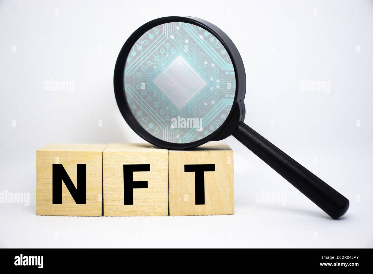 Hand holding wood cube block with 'NFT' text. NFT - short for Non ...