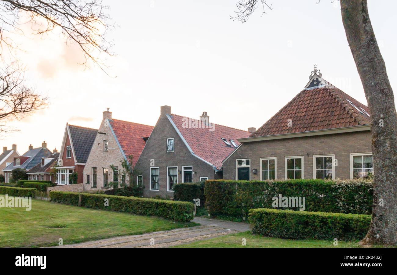 a row of old Dutch traditional houses on the wadden island of ...