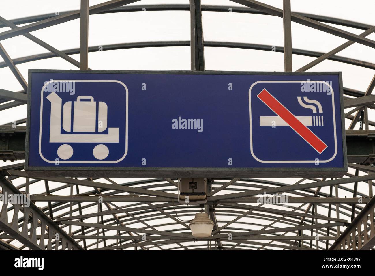 Luggage with Baggage cart and No Smoking sign on platform in train ...