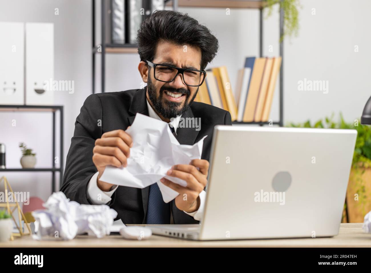 Angry furious indian man working at office throwing crumpled paper ...